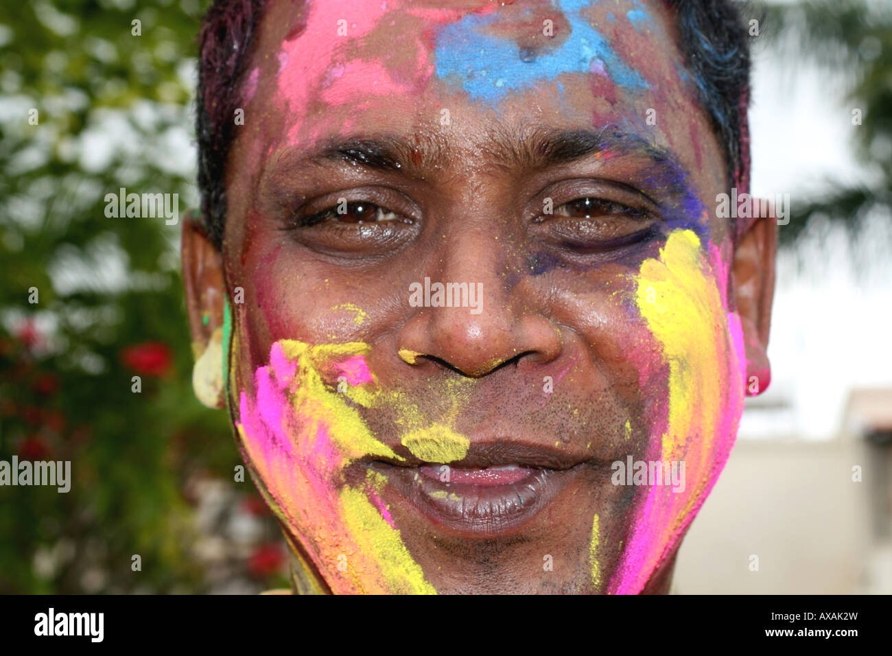 Face of Hindu man covered in Holi colours, India Stock Photo - Alamy