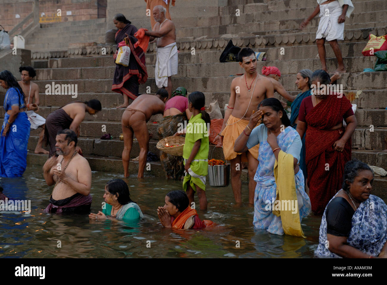 A group of Hindu's bathing and worshiping together on Kedar Ghat at ...