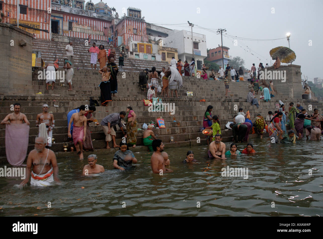 A group of Hindu's bathing and worshiping together on Kedar Ghat at ...