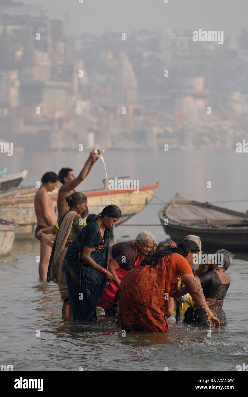 A group of Hindu's bathing and worshiping together on Kedar Ghat at ...