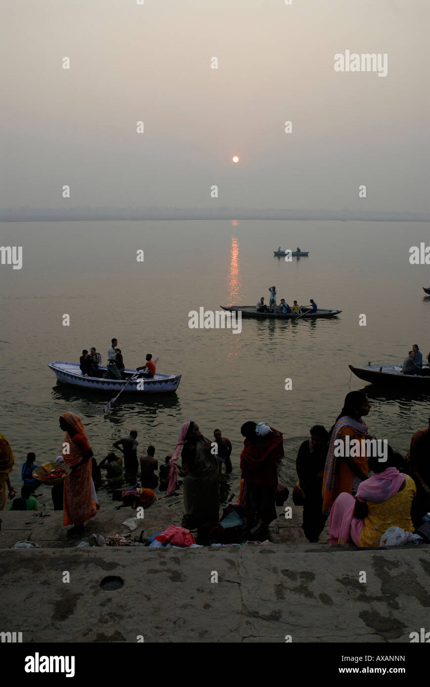 A group of Hindu's worshiping together on Kedar Ghat at sunrise on the ...