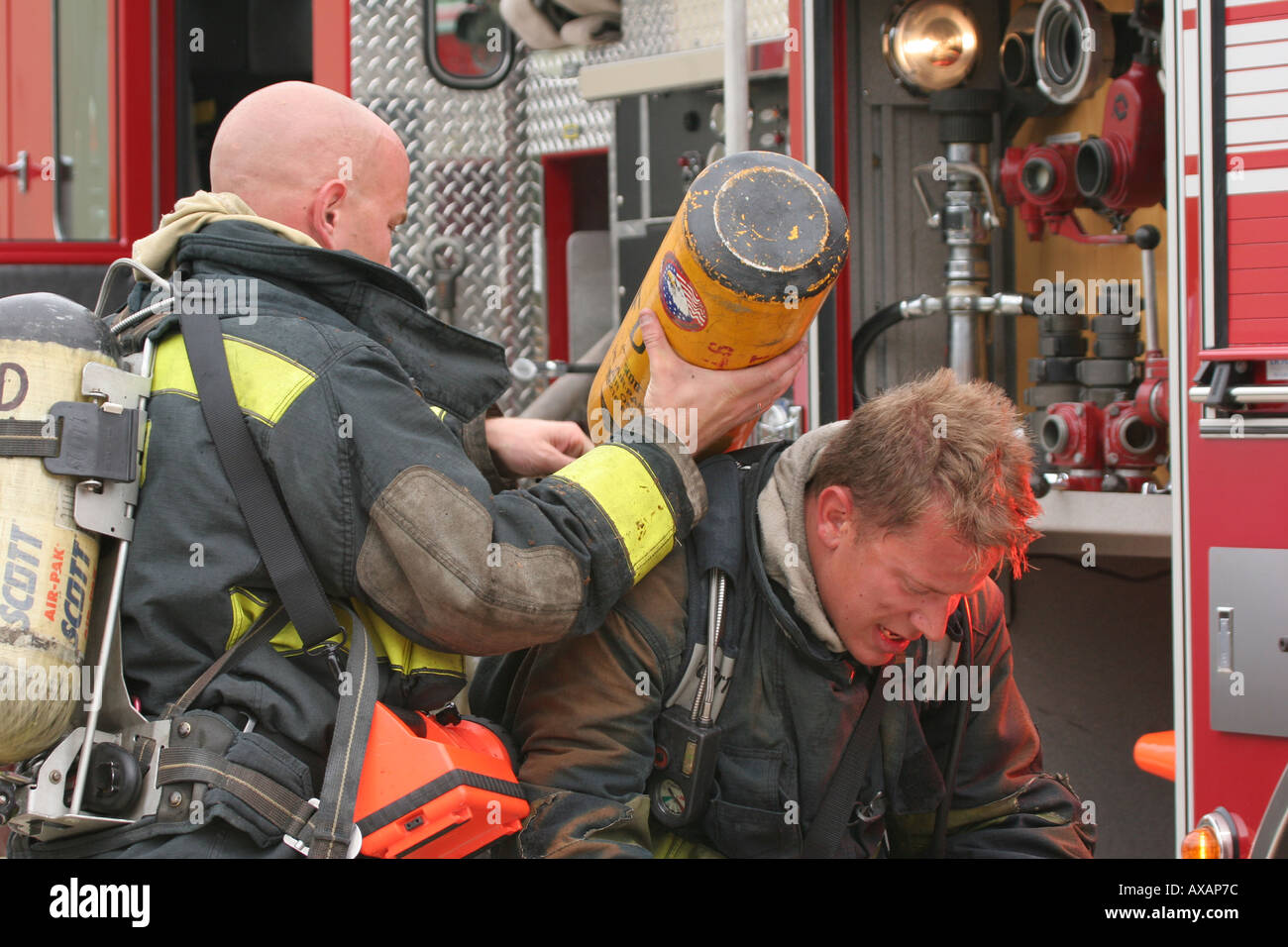 Fire fighter changing air bottle on fire equipment gear packs at the ...