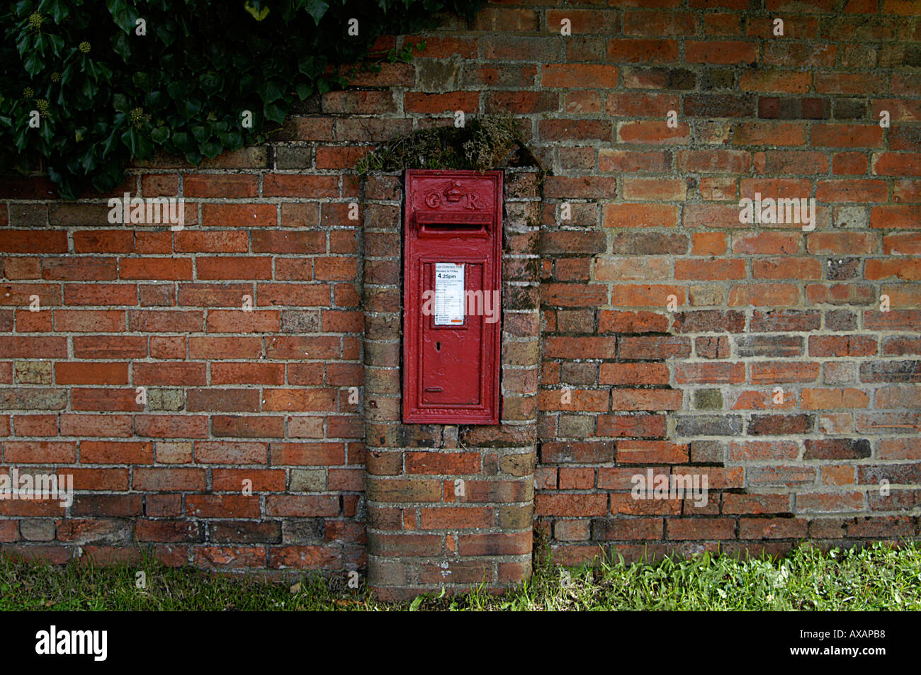 red letter box in a brick wall in the uk Stock Photo - Alamy