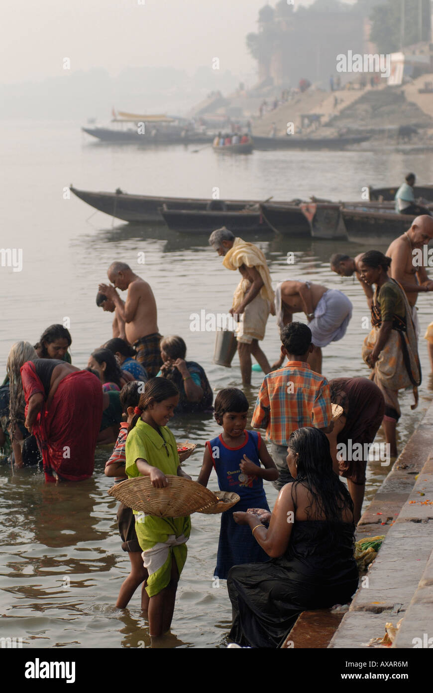 A group of Hindu's bathing and worshiping together on Kedar Ghat at ...