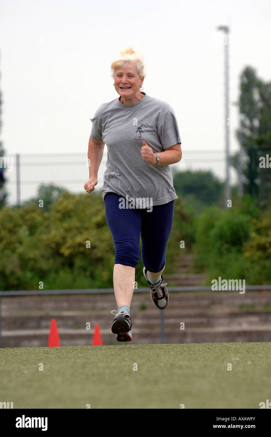 An elderly woman jogging Stock Photo - Alamy