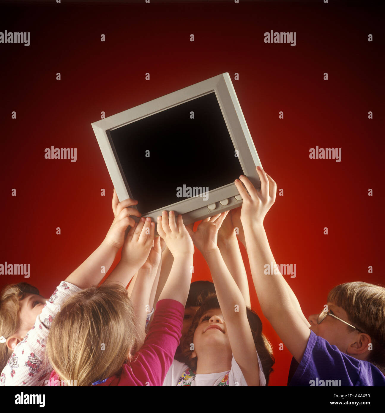 School children lift computer monitor, access to technology Stock Photo ...