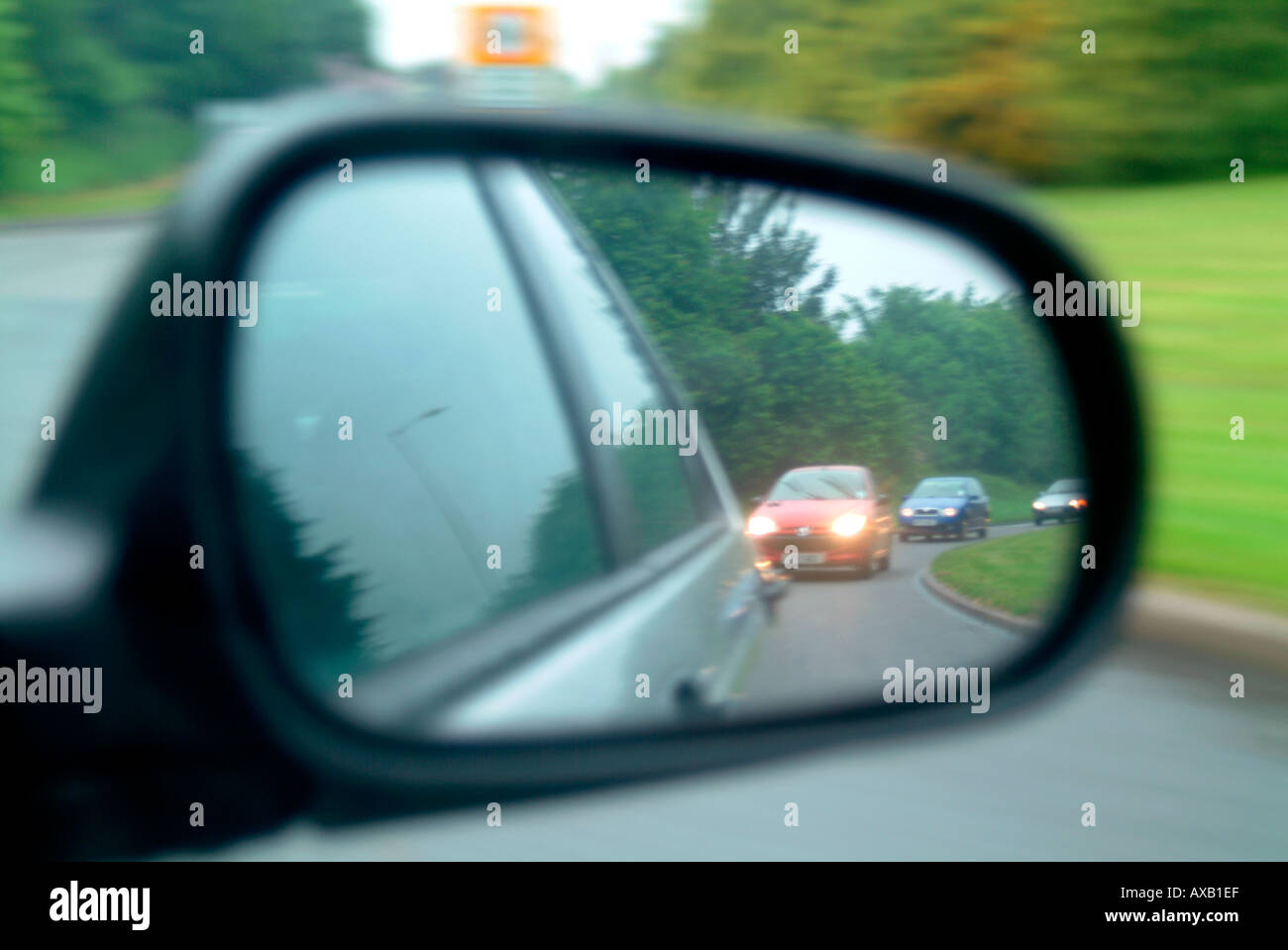 Driver eye view of rear view mirror in bad wet weather Stock Photo - Alamy