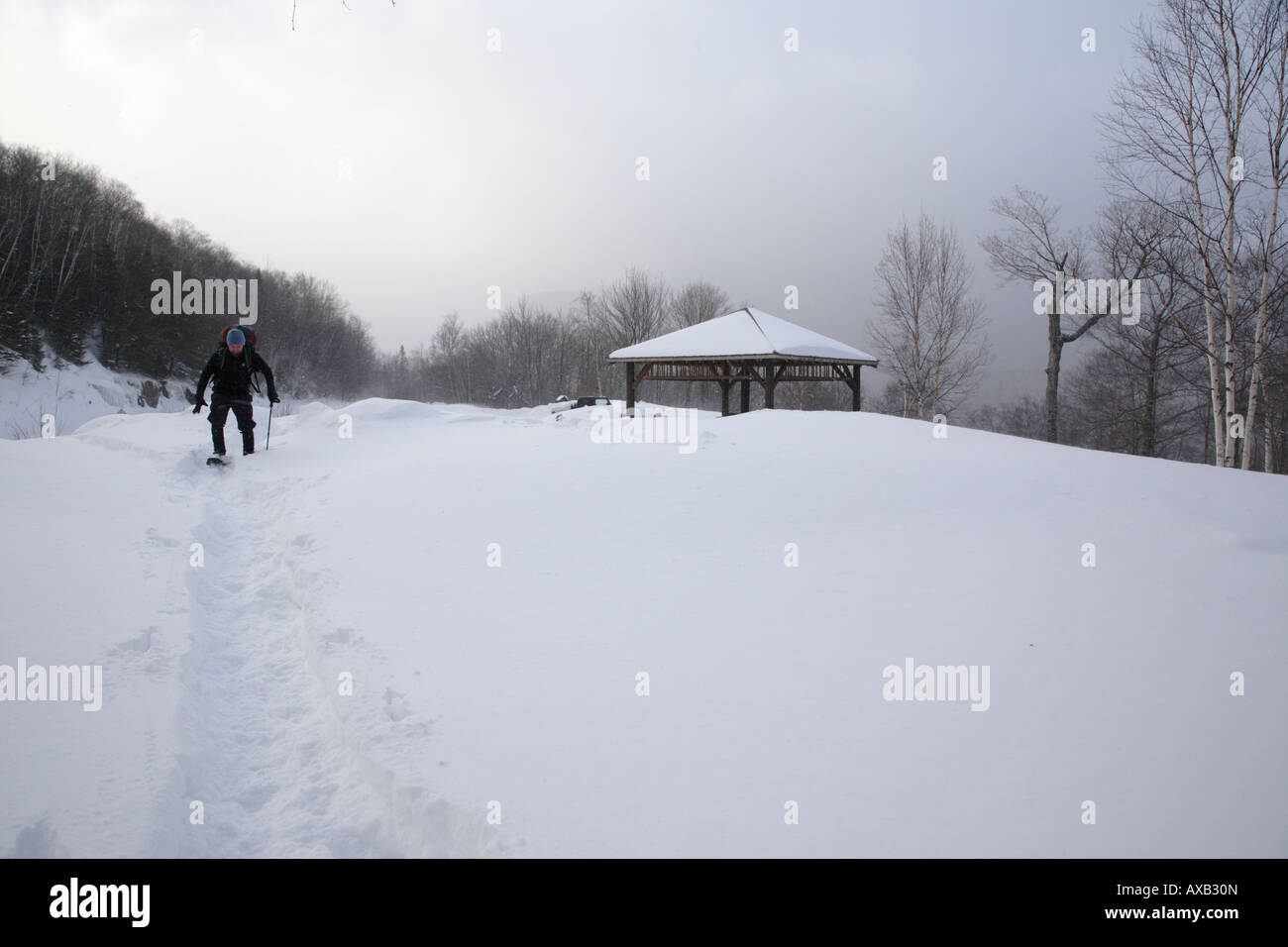 Hikers snowshoeing on the Hancock Notch Trail during the winter months ...