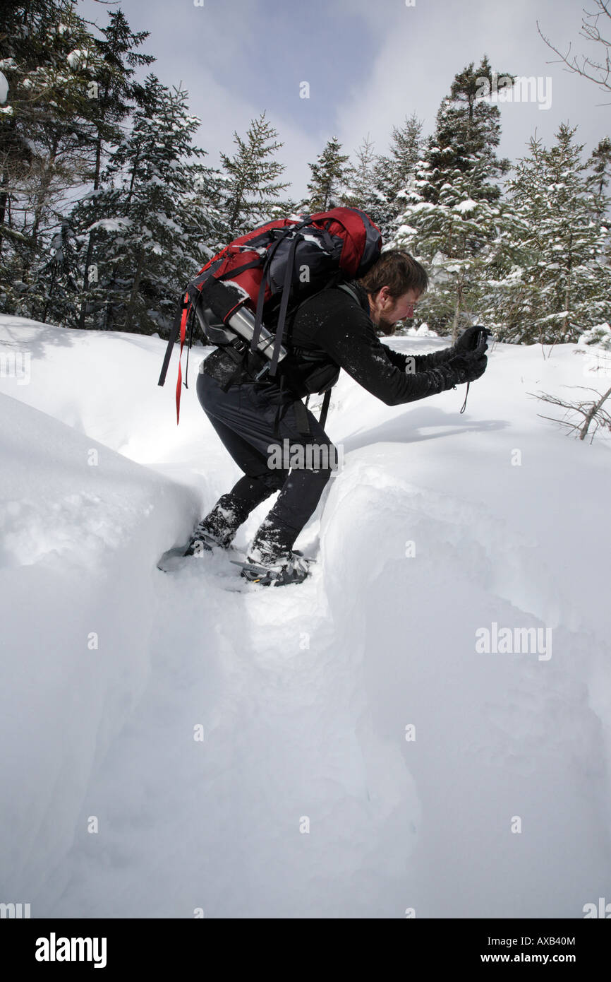 Hikers snowshoeing on the Hancock Notch Trail during the winter months ...