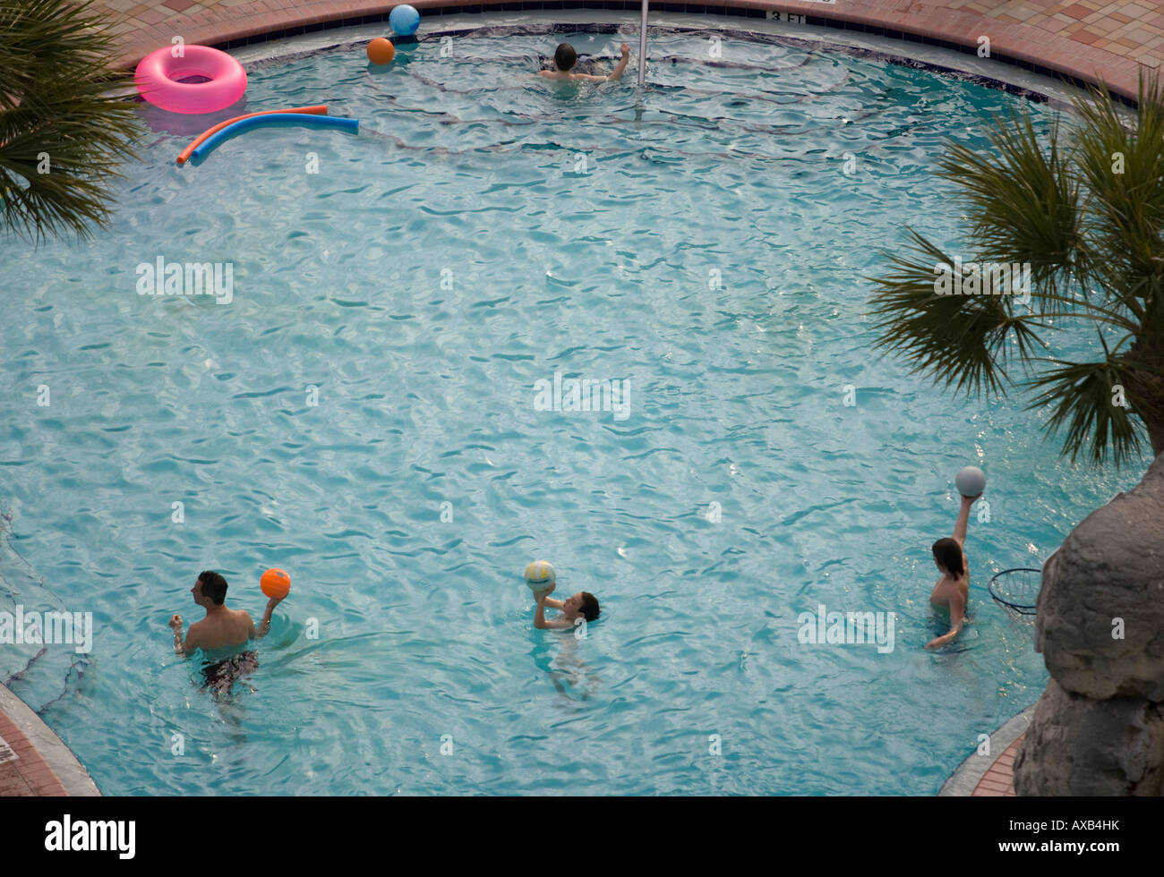 Boys holding basketballs in a pool Stock Photo - Alamy