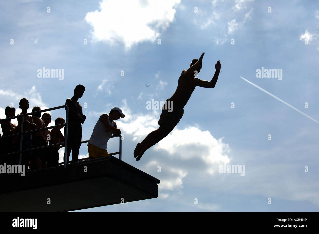 A man jumping off a springboard Stock Photo - Alamy