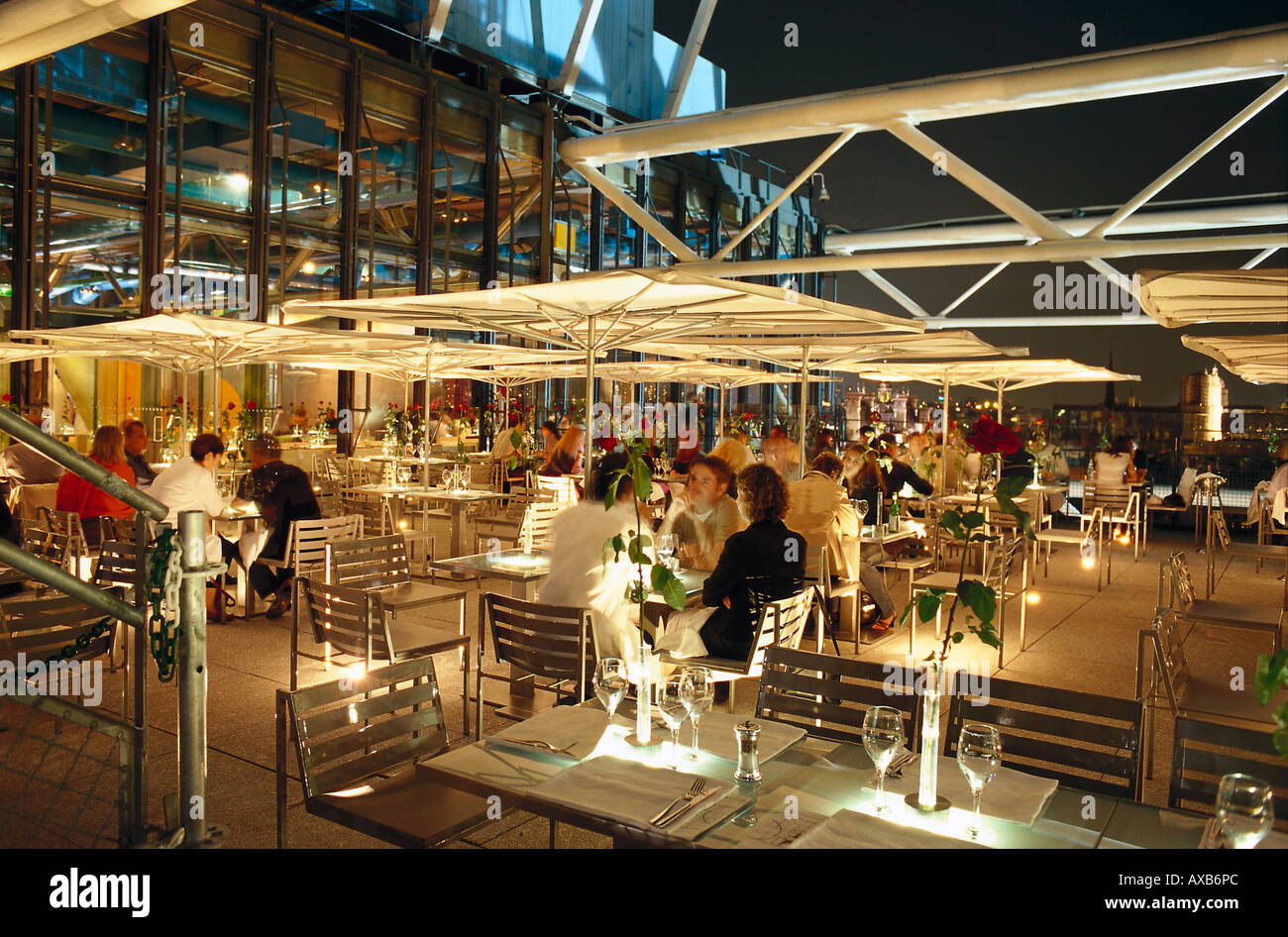 People sitting on the terrace of the Restaurant Le Georges at night ...