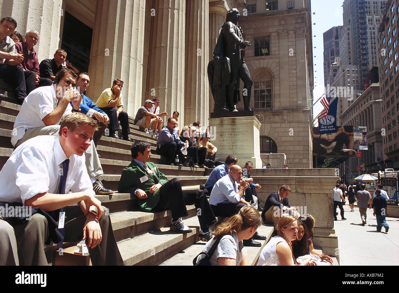 People sitting on steps in the sunlight, Wall Street, Financial ...