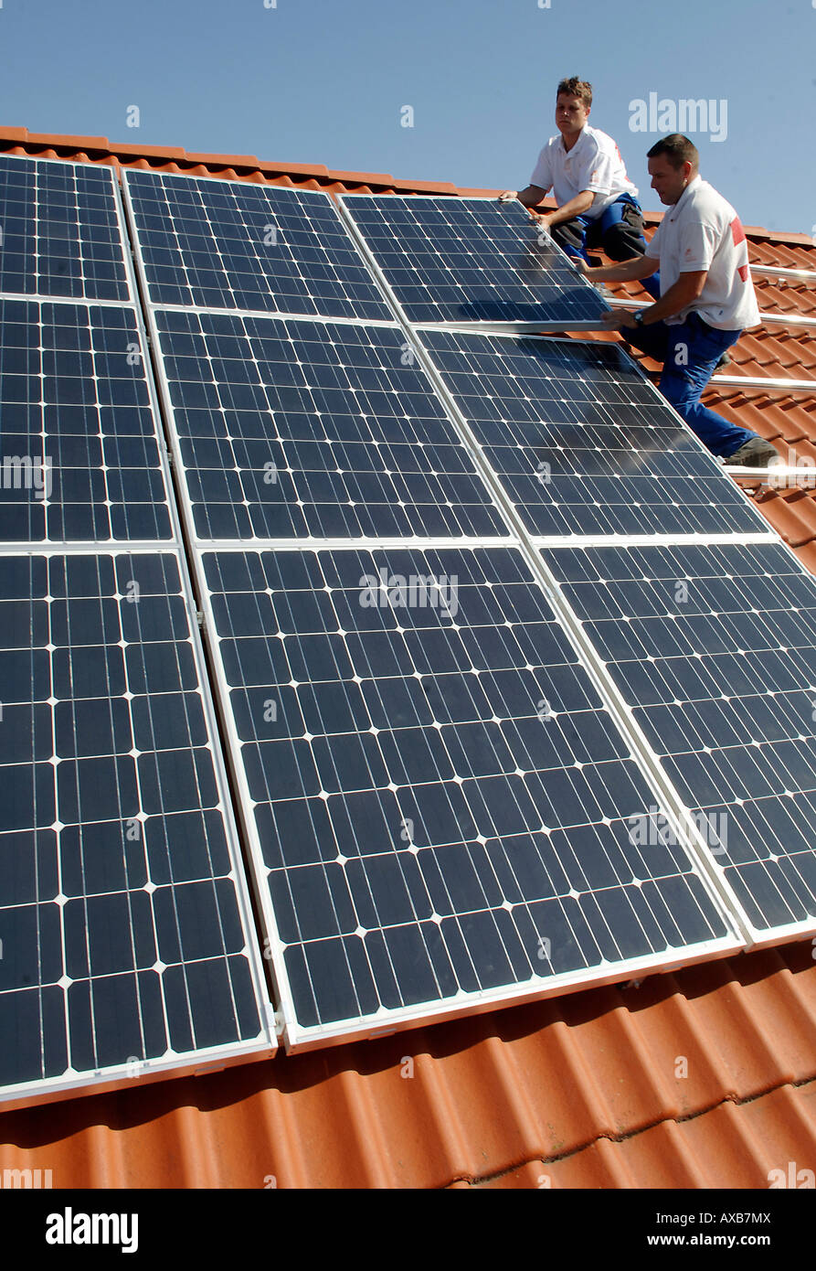 Installation of solar panels on a roof Stock Photo - Alamy