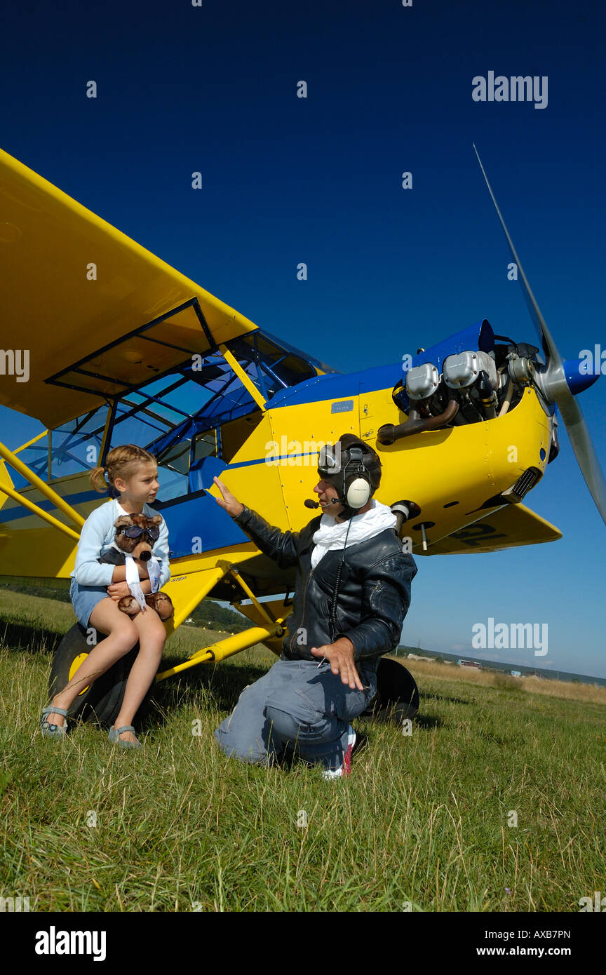 A father private pilot with his young daughter around a famous Piper J ...