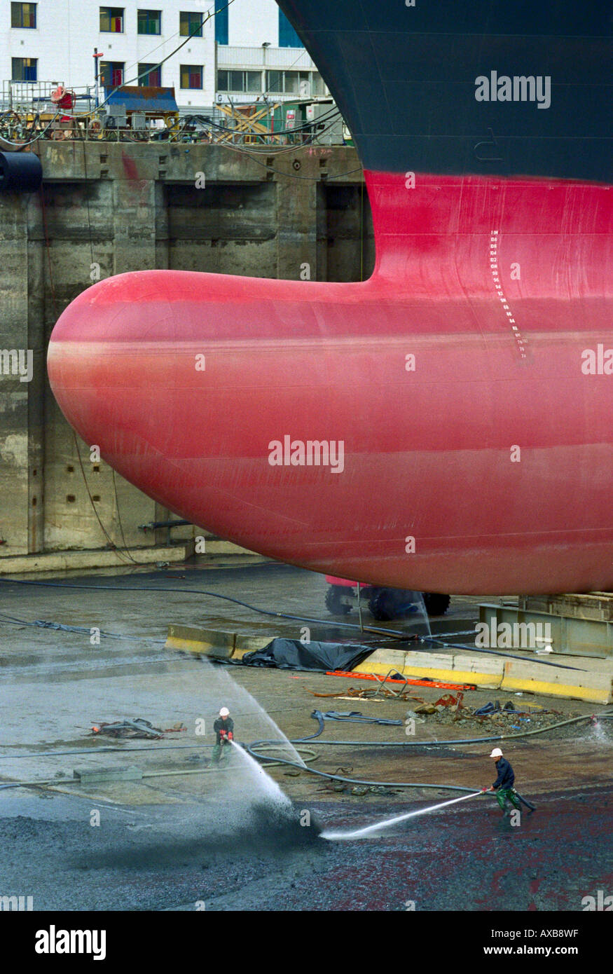 Two workers cleaning the dry dock, dry dock, Queen Mary 2, Saint ...