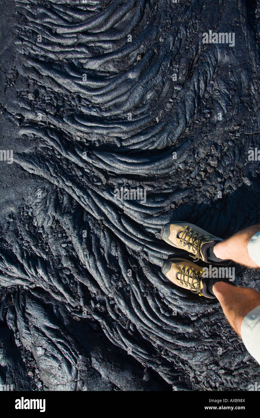 A man s feet and legs standing on Pahoehoe lava in Hawai i Volcanoes ...