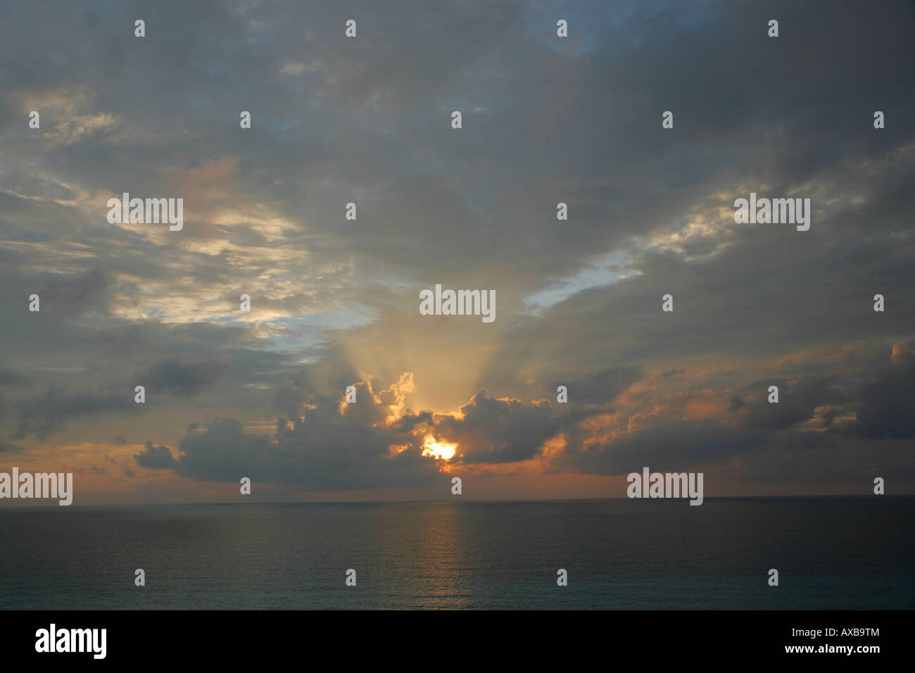 Sun rays bursting through clouds, sunrise, Cancun, Mexico Stock Photo ...
