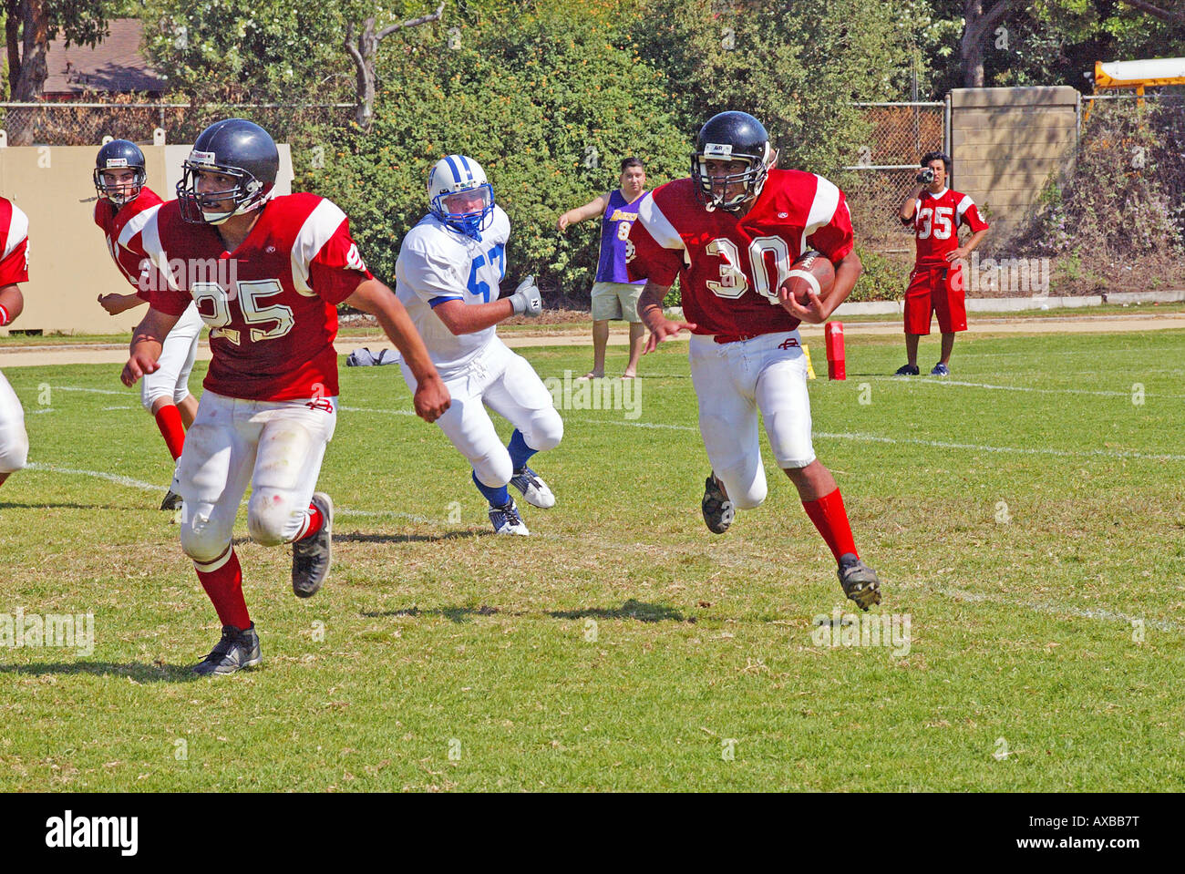High school football game action Stock Photo - Alamy