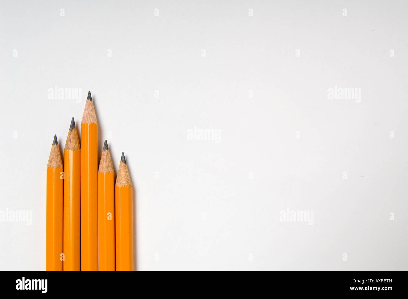 Five pencils pointing up on a white background Stock Photo - Alamy