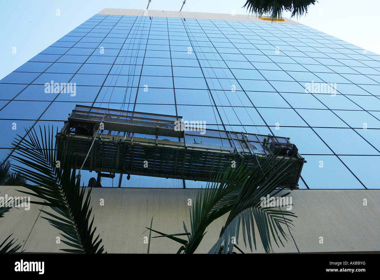 Window washing scaffold on side of tall building Stock Photo - Alamy