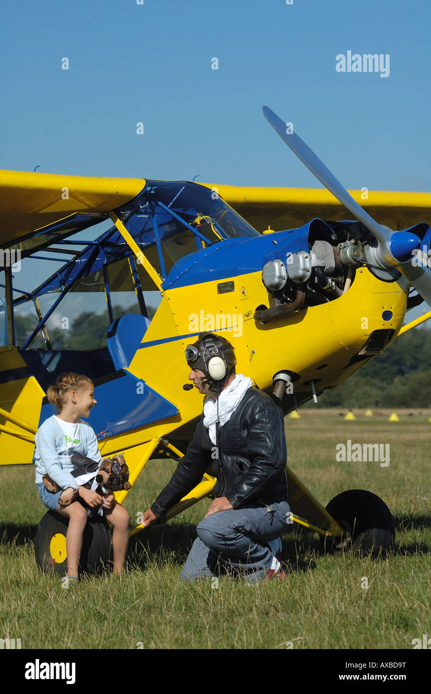 A father private pilot with his young daughter around a famous Piper J ...