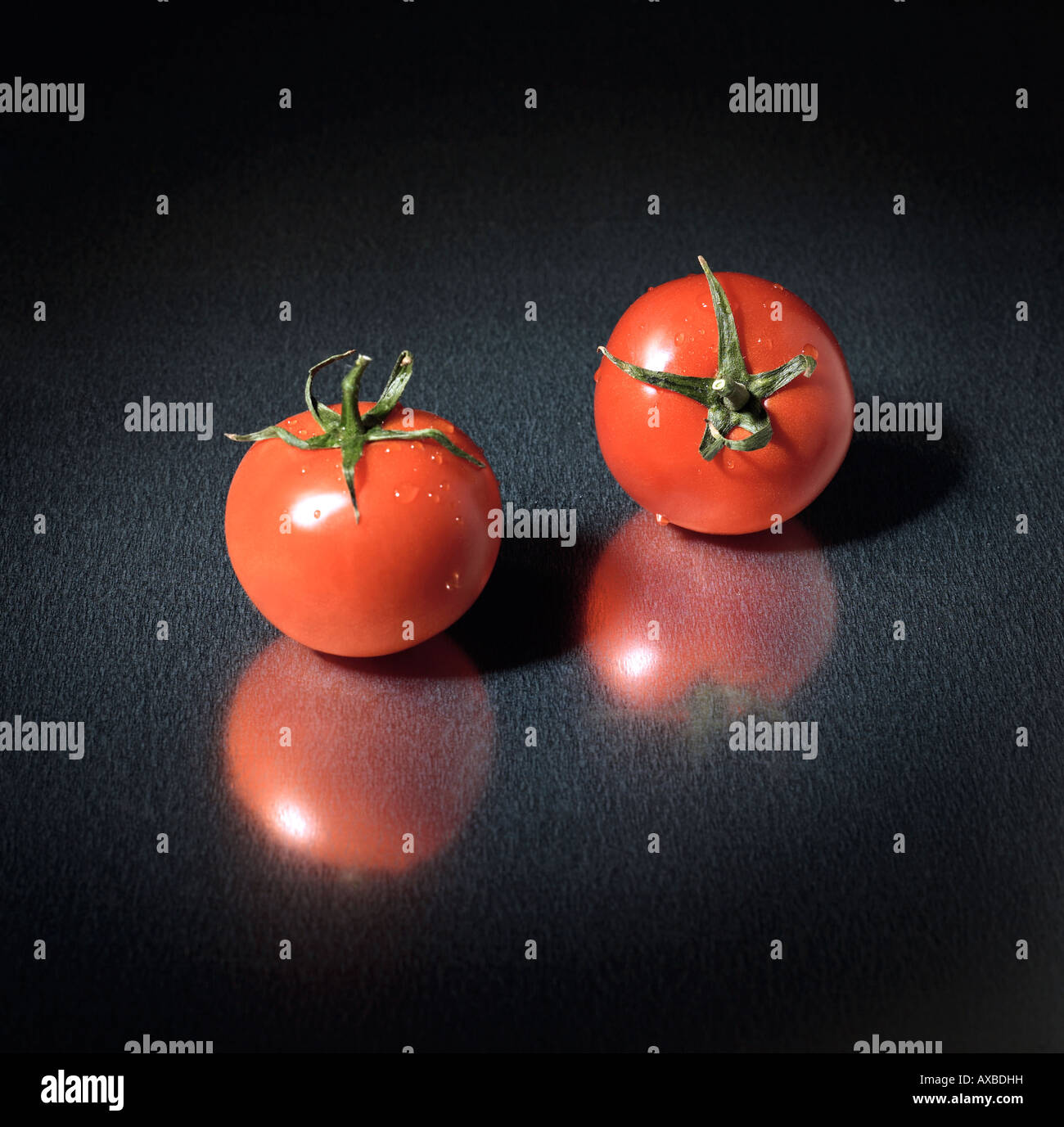 Two red tomatoes on stainless steel surface Stock Photo - Alamy