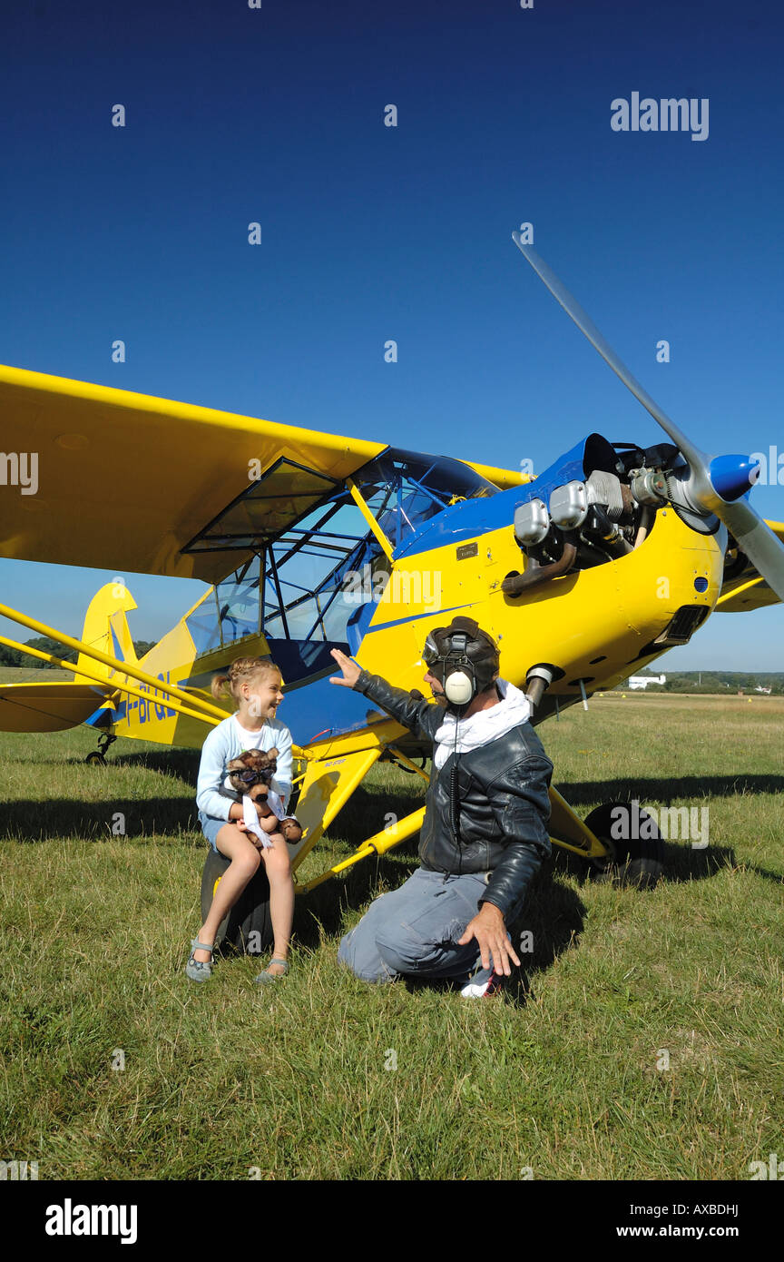A father private pilot with his young daughter around a famous Piper J ...
