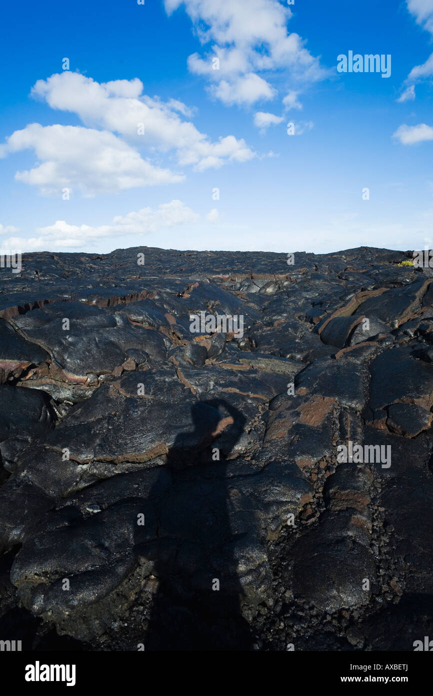 Shadow of photographer on lava flows in Hawaii Vocanoes National Park ...