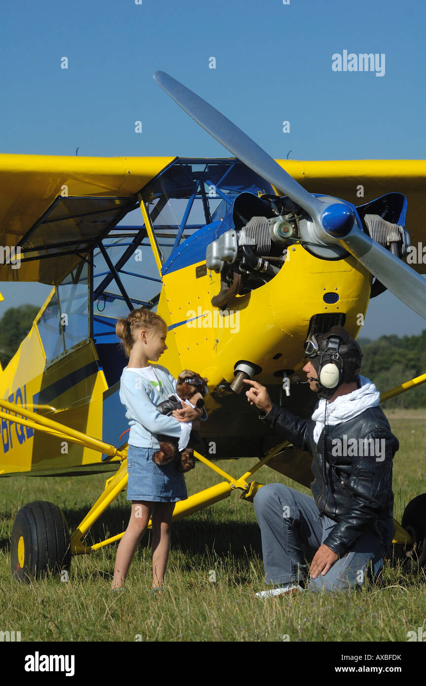 A father private pilot with his young daughter learning a flying lesson ...