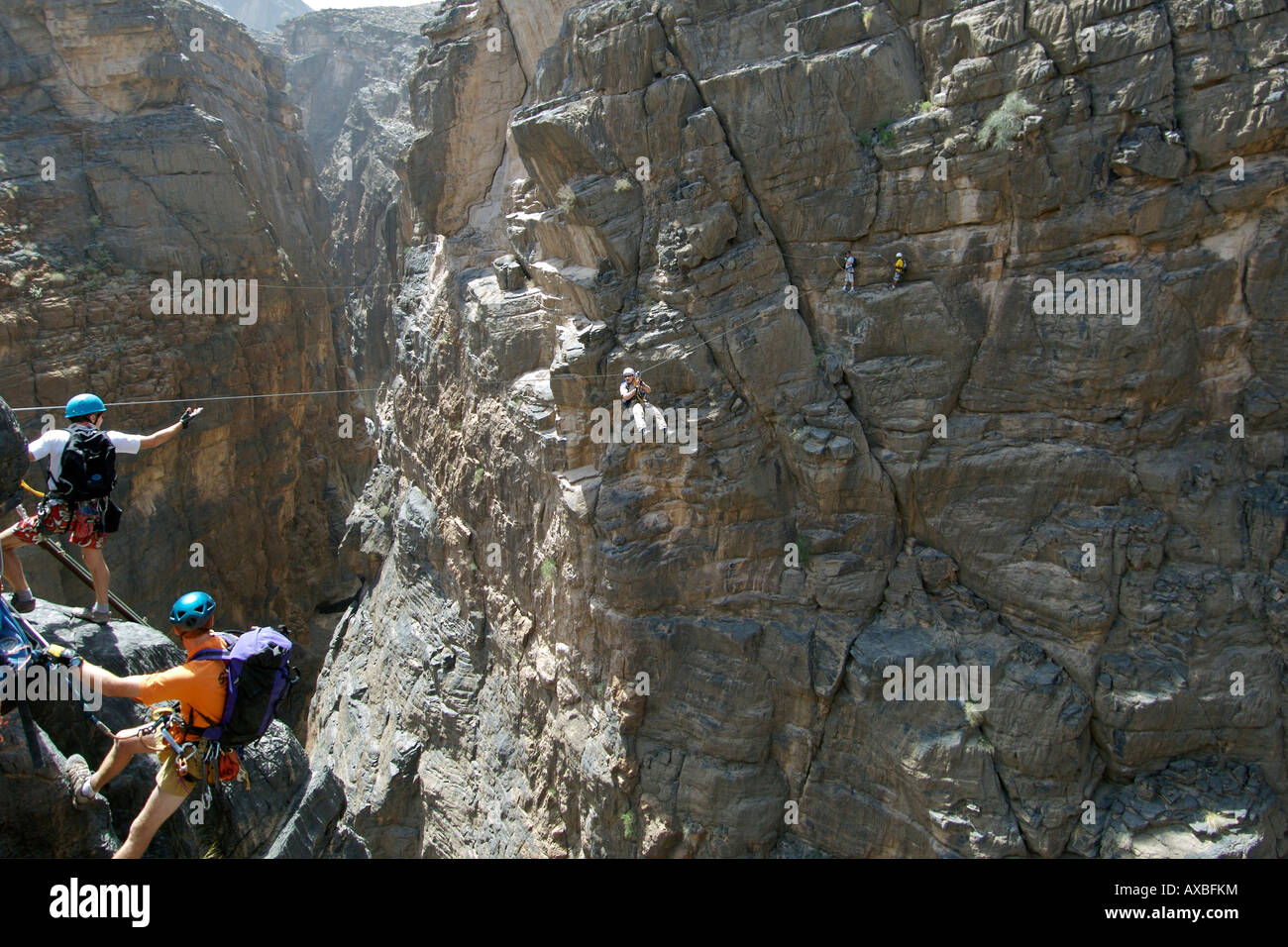 A hiker traversing a zip wire (a.k.a. flying fox) on the Via Ferrata ... A hiker traversing a zip wire (a.k.a. flying fox) on the Via Ferrata ...