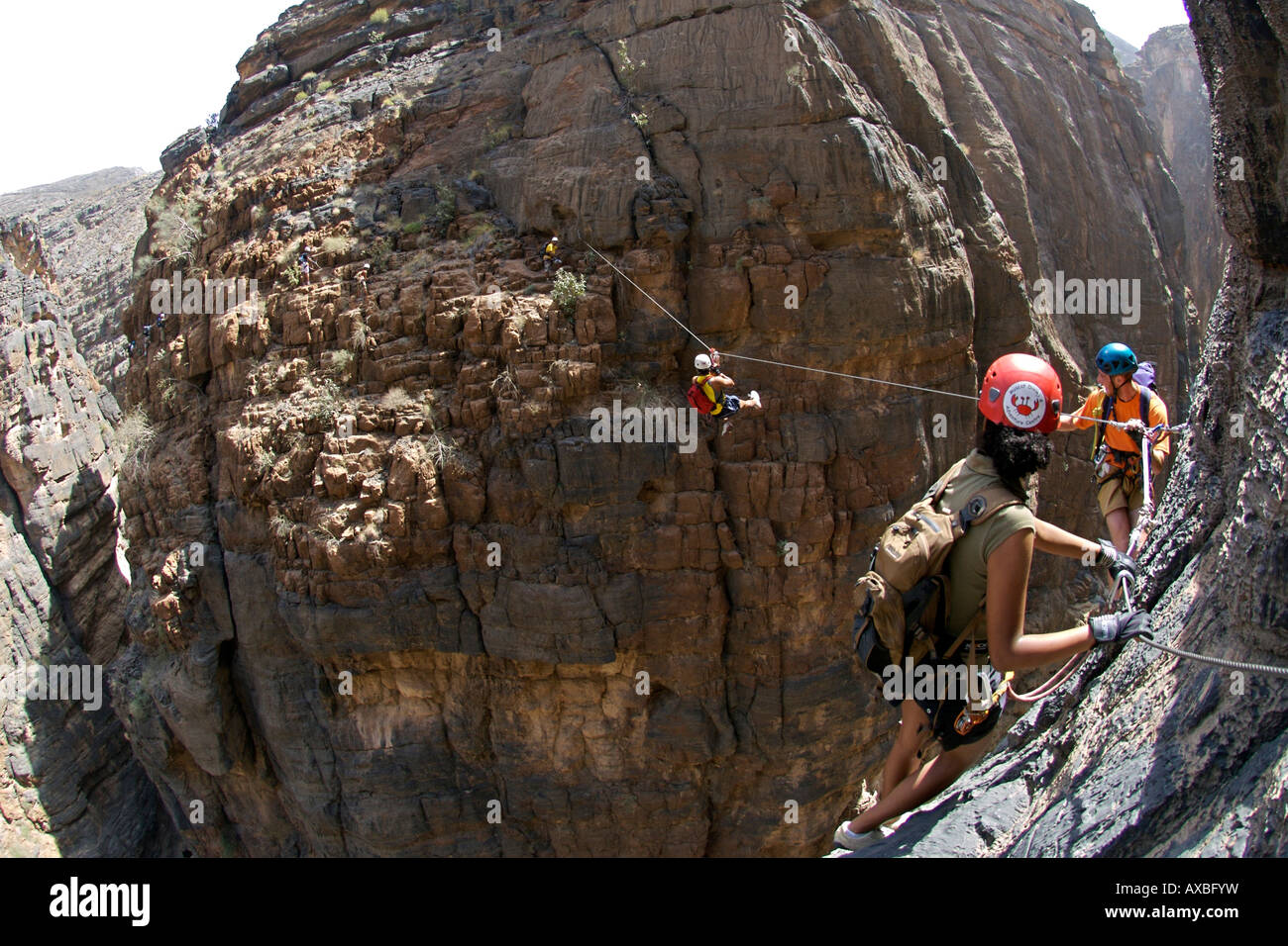 A hiker traversing a zip wire (a.k.a. flying fox) on the Via Ferrata ... A hiker traversing a zip wire (a.k.a. flying fox) on the Via Ferrata ...