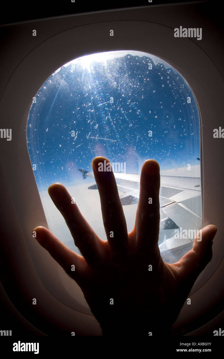 A hand at a window of an aeroplane Stock Photo - Alamy