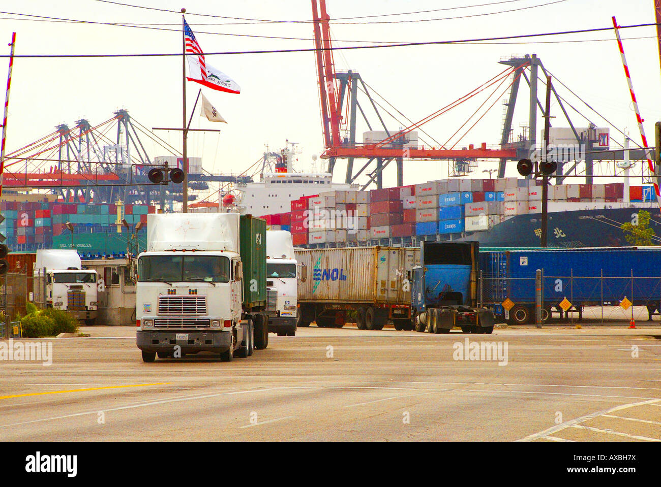 Trucks load and unload shipping containers at Los Angeles Harbor ...
