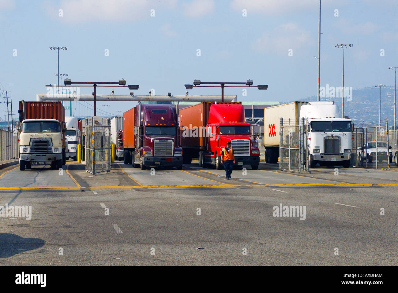Trucks load and unload shipping containers at Los Angeles Harbor ...