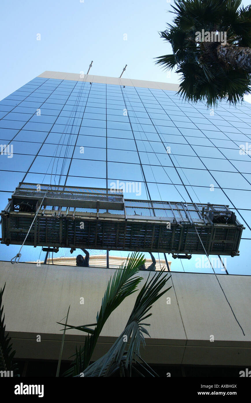 Window washing scaffold on side of tall building Stock Photo - Alamy