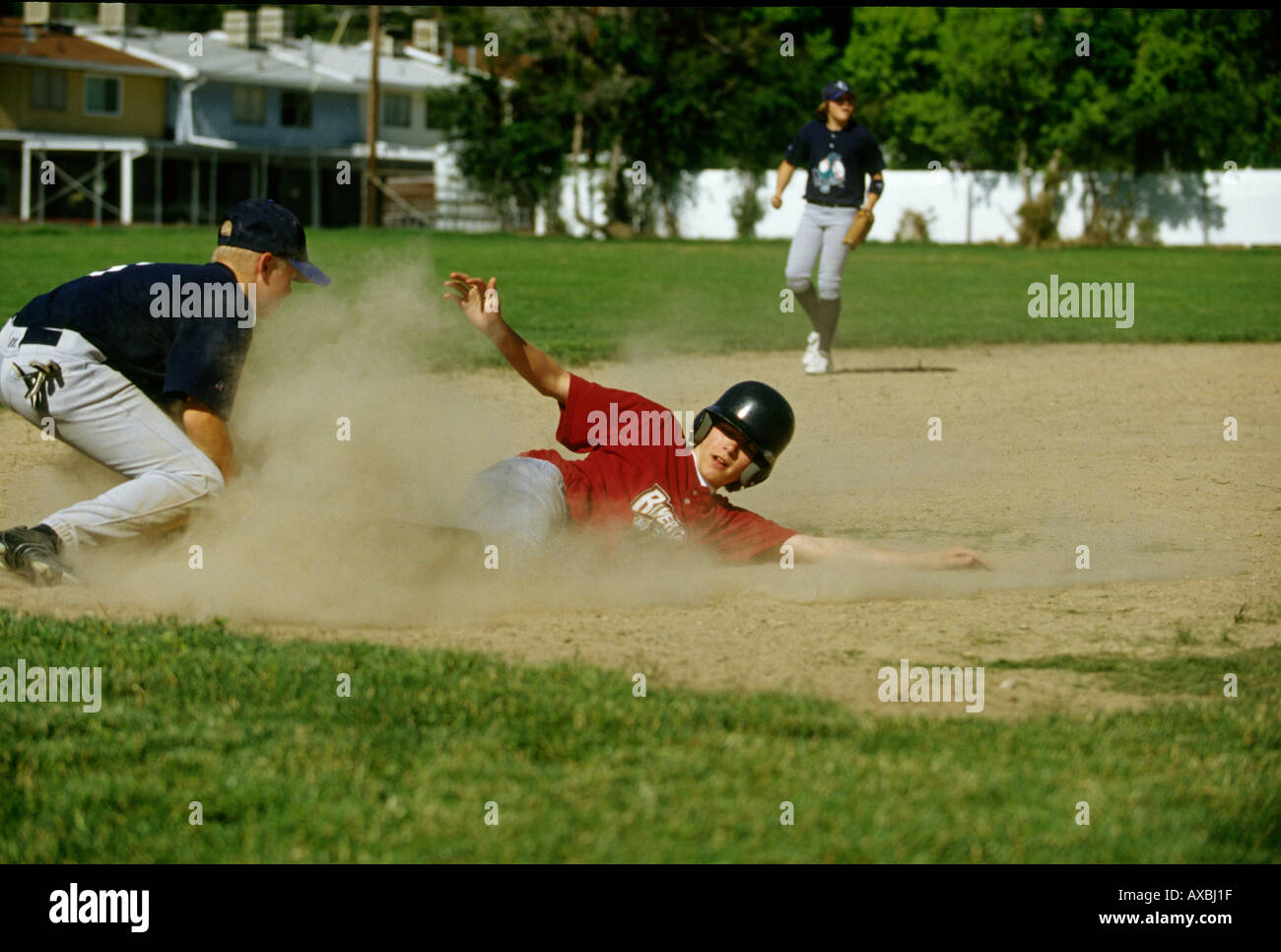 Baseball player sliding into third base Stock Photo - Alamy