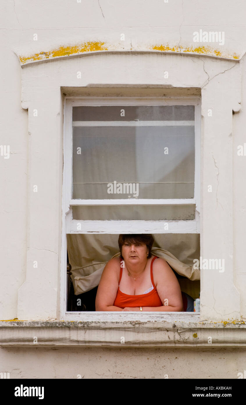 Woman looking out of upstairs window at parade during annual Newent ...