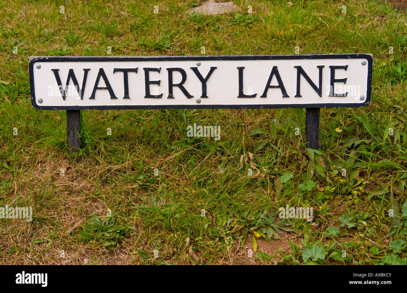 WATERY LANE street sign on grass at Newent Gloucestershire England UK ...