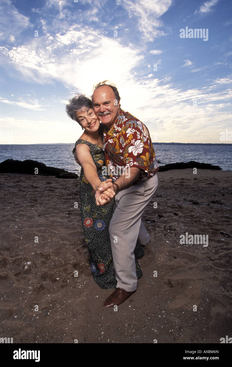 Senior couple dancing on the beach, smiling, sunset, Connecticut, USA ...