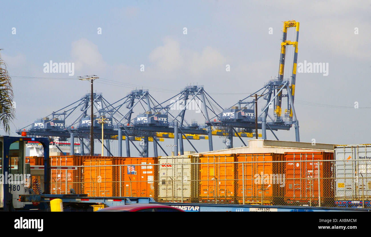 Trucks load and unload shipping containers at Los Angeles Harbor ...