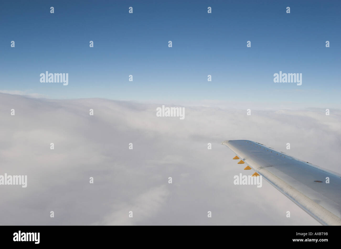 Horizontal section of jet wing and clouds in distance Stock Photo - Alamy