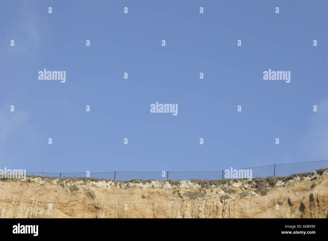Cliff top clear blue sky and fence - side view Stock Photo - Alamy