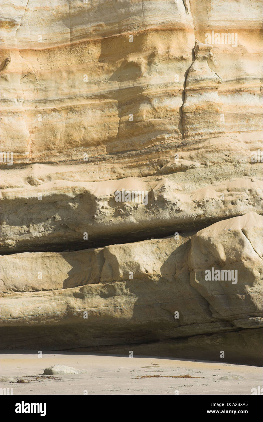 Vertical image of striated rock formation from beach Stock Photo - Alamy