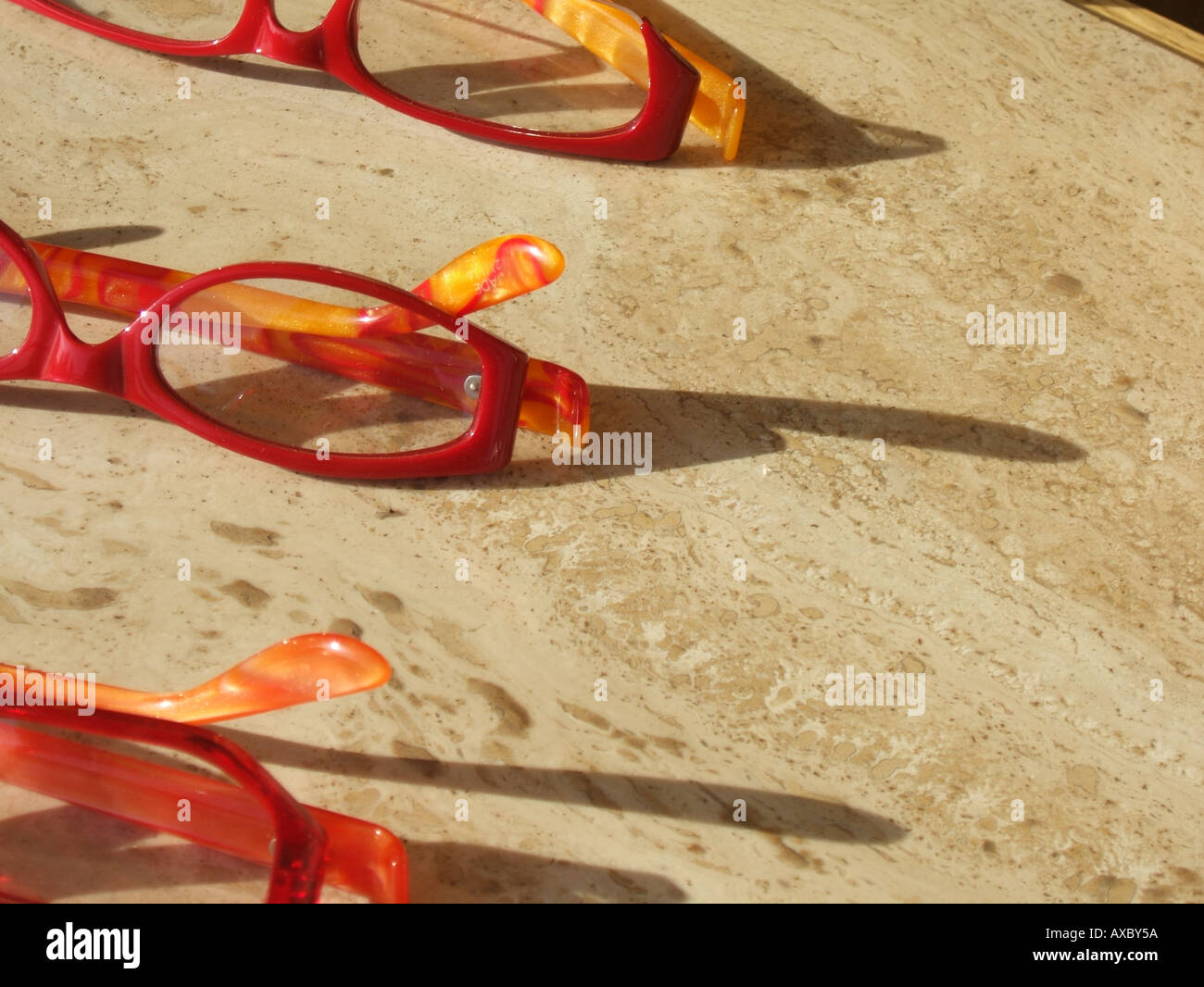 three colourful orange spectacles at opticians Stock Photo - Alamy