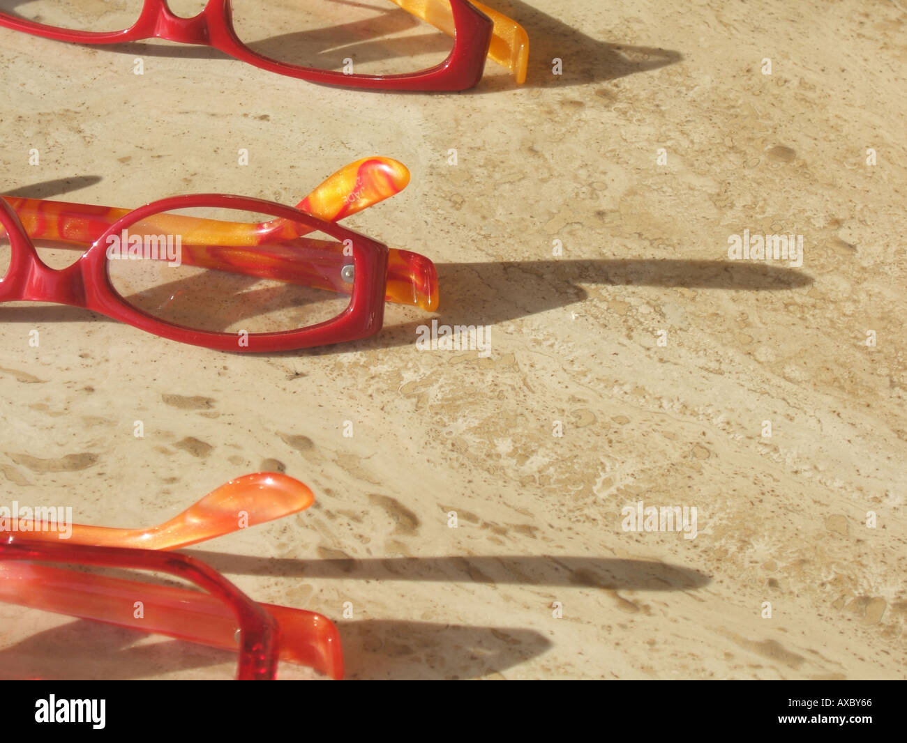 three colourful orange spectacles at opticians Stock Photo - Alamy