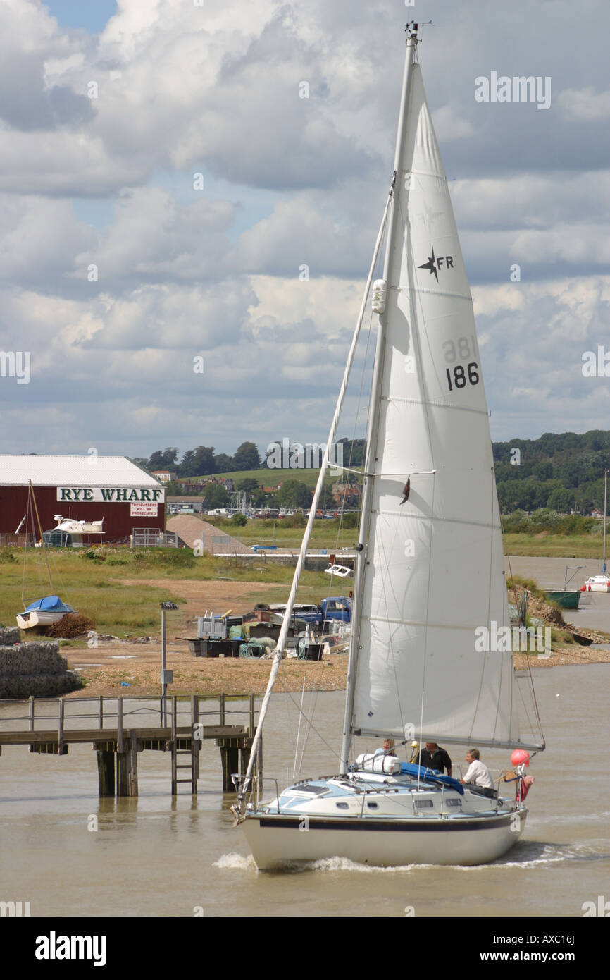 white sunlit single sail sailing boat mast rigging river rother rye ...
