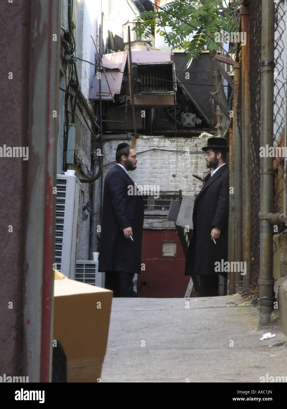 Jewish men in traditional clothes smoking in the backyard, USA ...