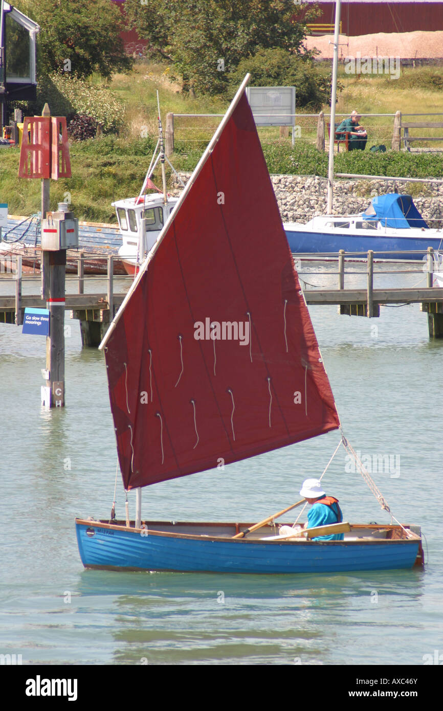 red square raised sail rowing boat high tide river rother rye east ...