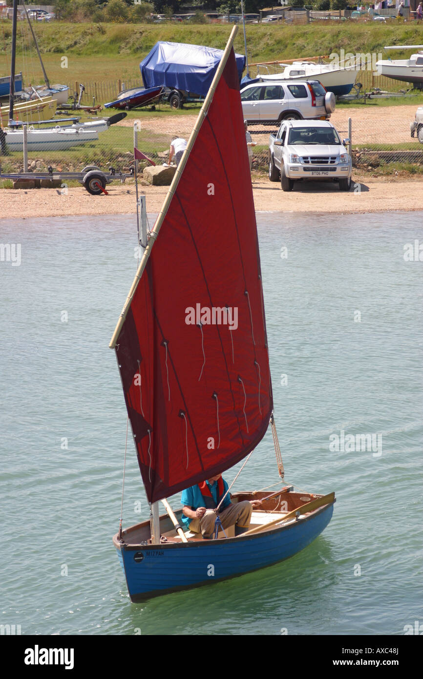 red square raised sail rowing boat high tide river rother rye east ...